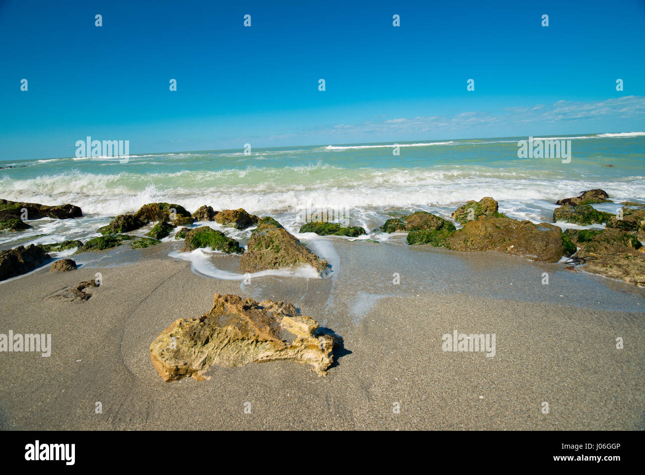 waves over rocky beach shore line Stock Photo - Alamy