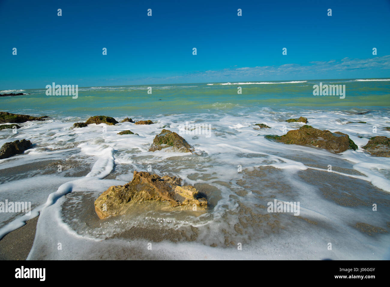 waves over rocky beach shore line Stock Photo - Alamy