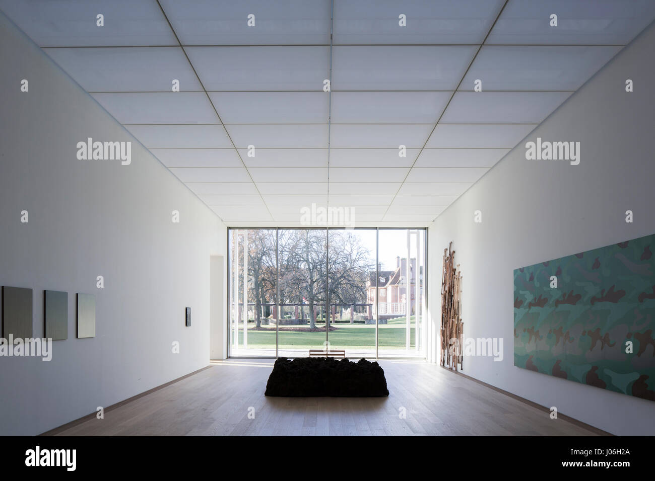 Exhibition space with window wall and view towards park grounds. Museum ...
