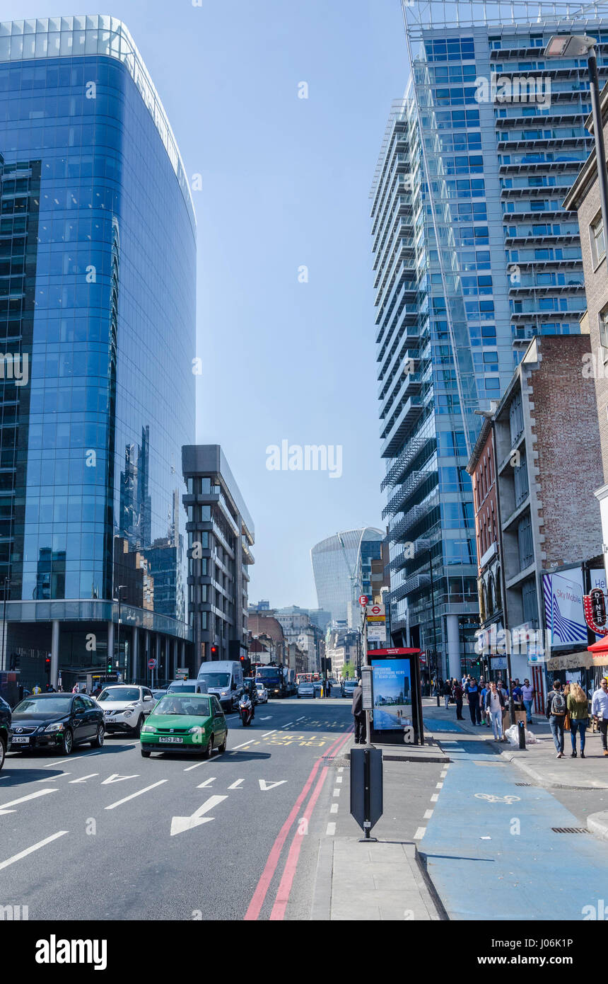 A view down Whitechapel High Street lined with tall, modern buildings ...