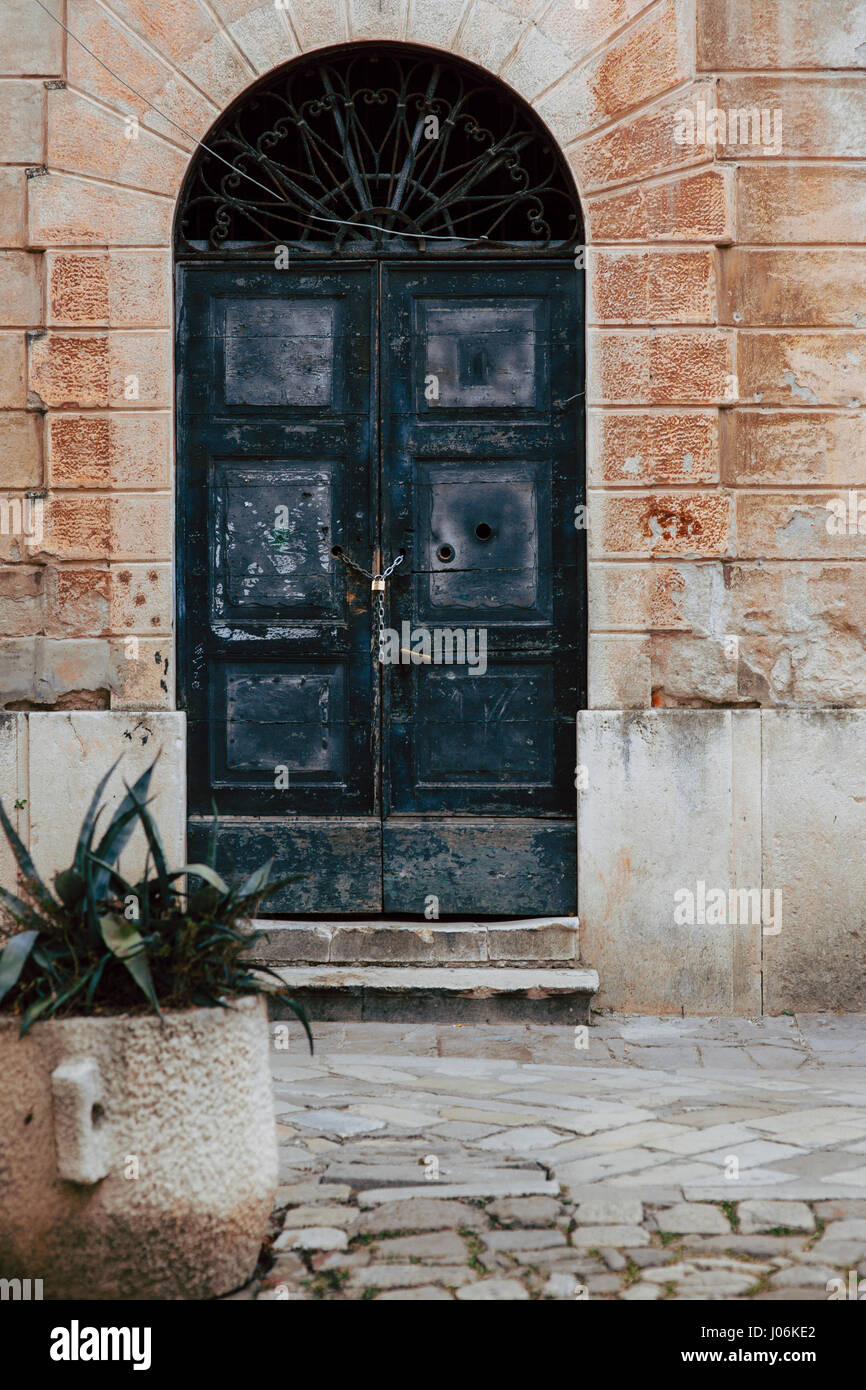Old black doors. Wood texture. Texture of metal. Old shabby, irradiated ...