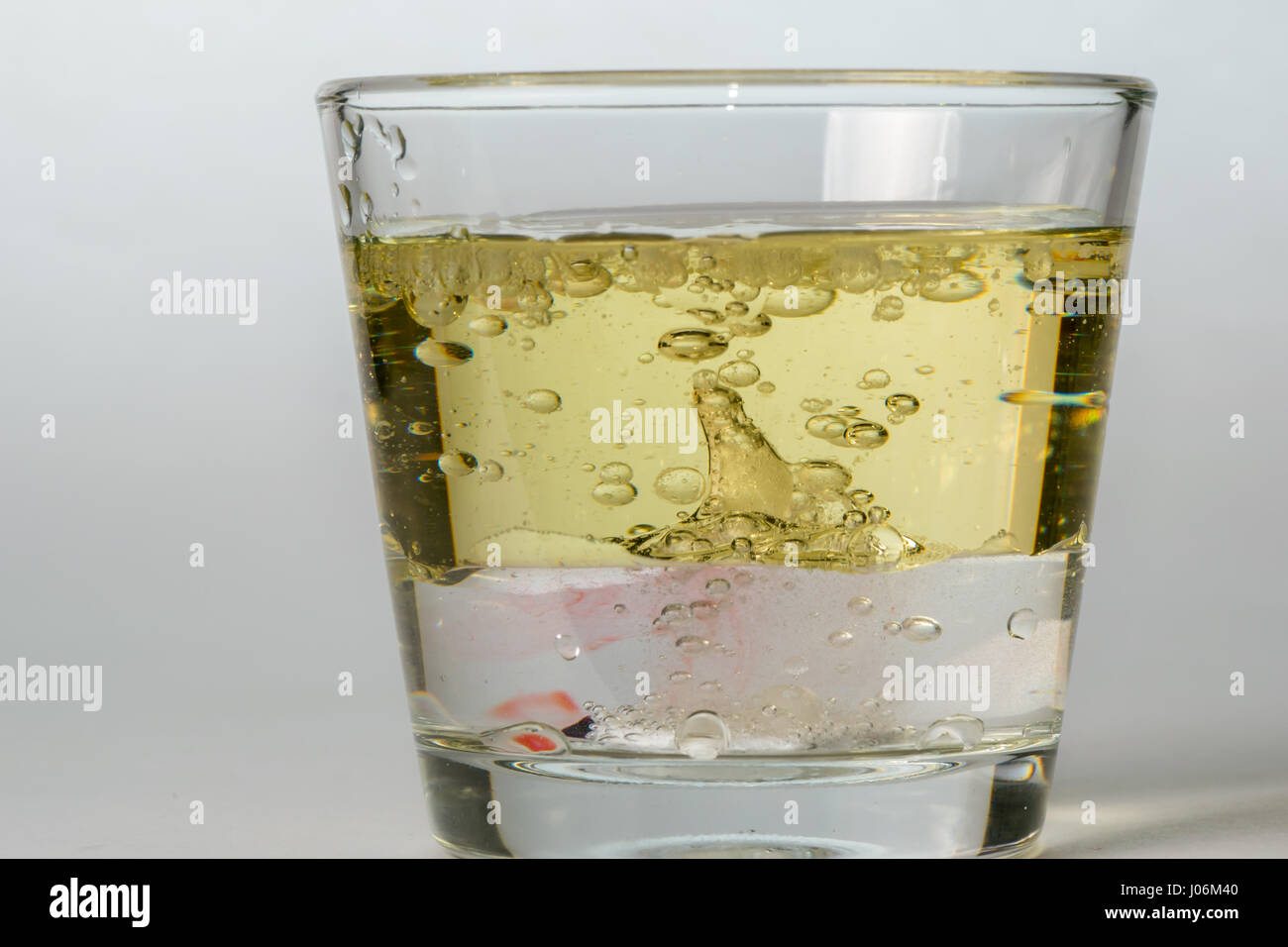 glass with drops of colored bubbles in water and oil Stock Photo - Alamy