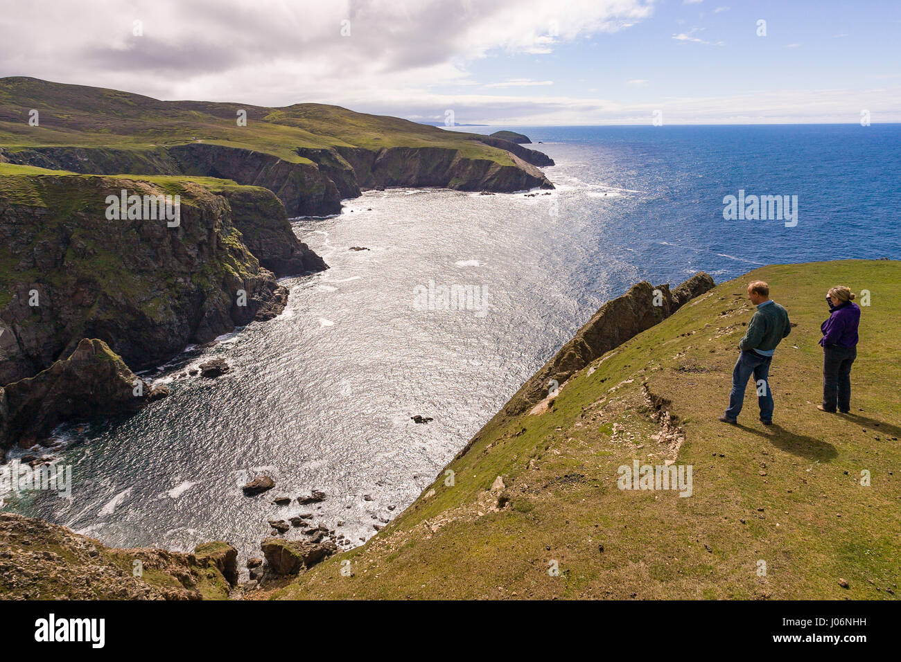 ARAN ISLAND, DONEGAL, IRELAND - Visitors on bluff, Atlantic coast ...