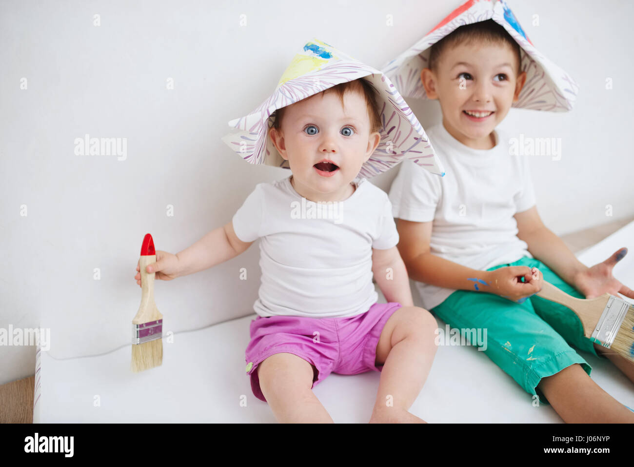 happy children painting wall at home Stock Photo - Alamy