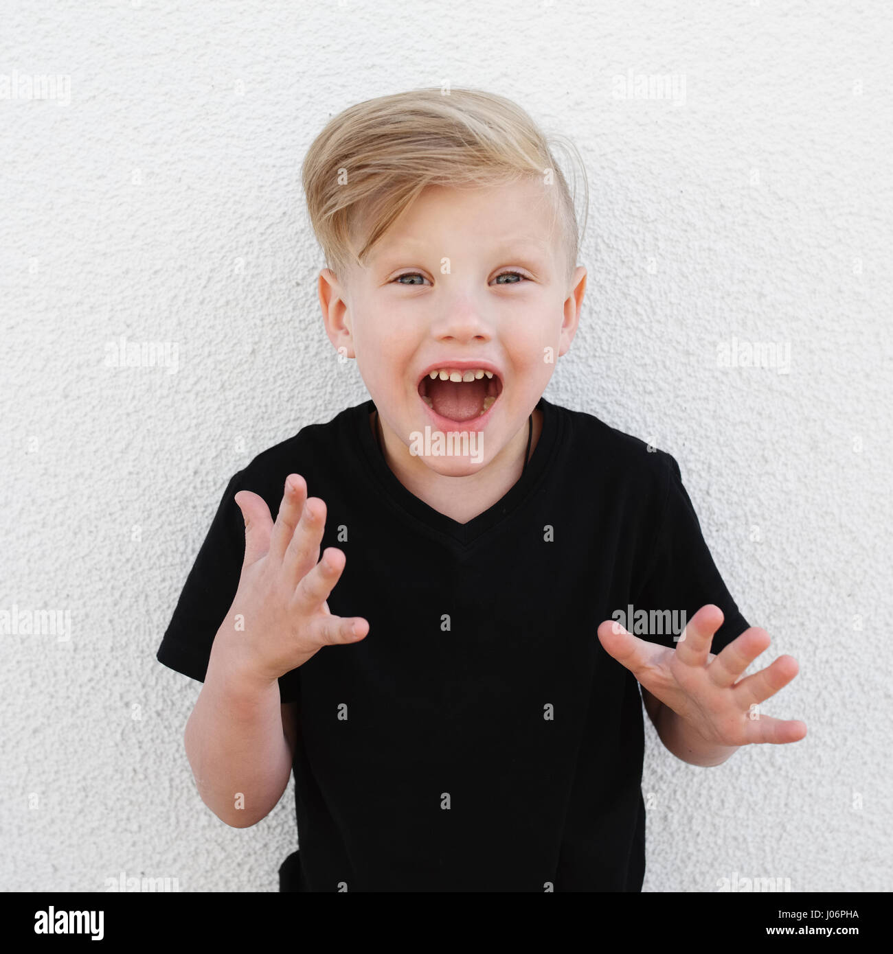 young emotional boy on bright background Stock Photo - Alamy