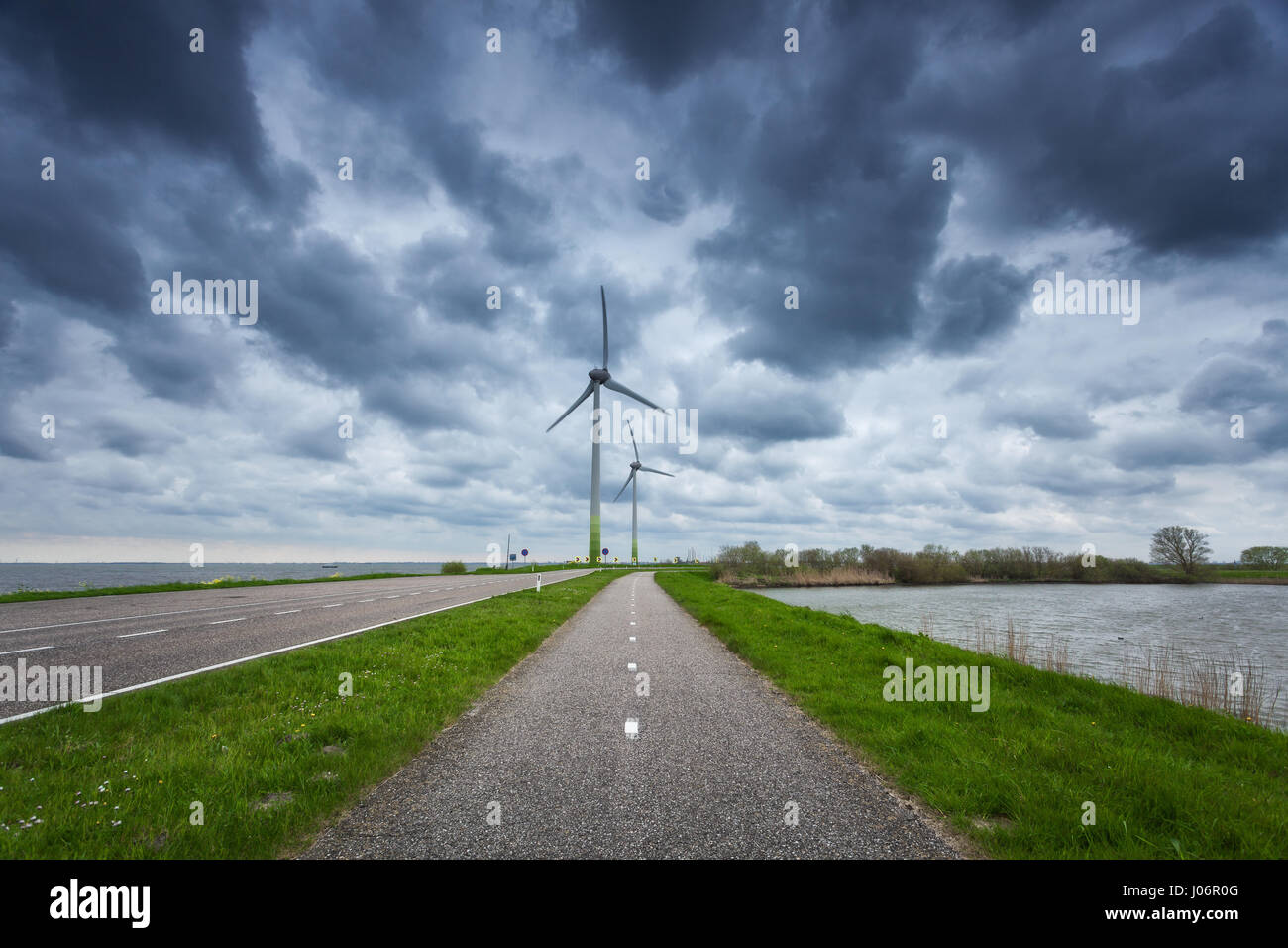 Beautiful asphalt road with wind turbines generating electricity ...