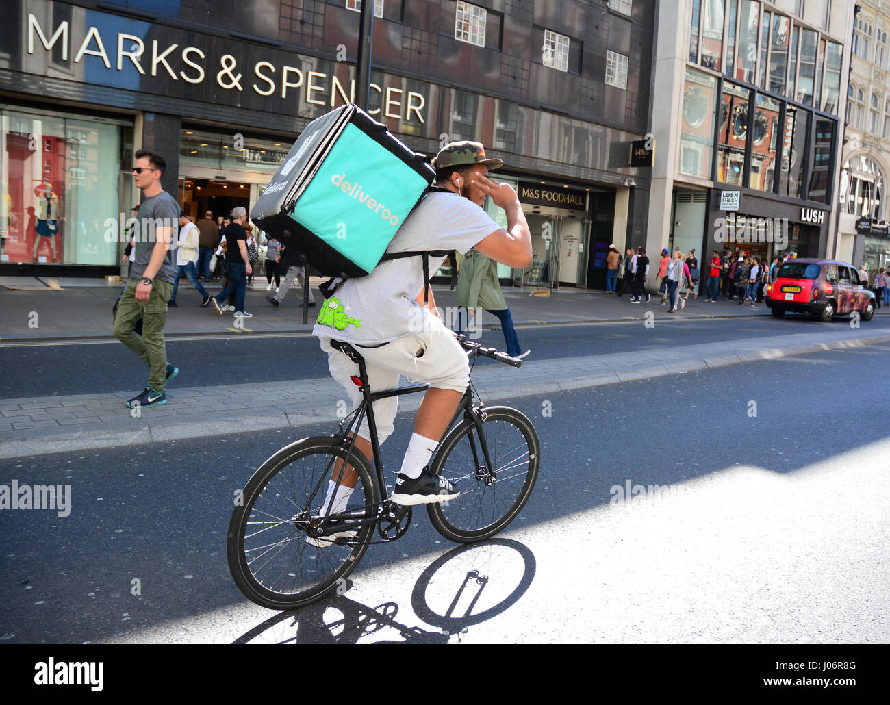 Deliveroo rider making a rude two finger gesture in London, UK Stock ...