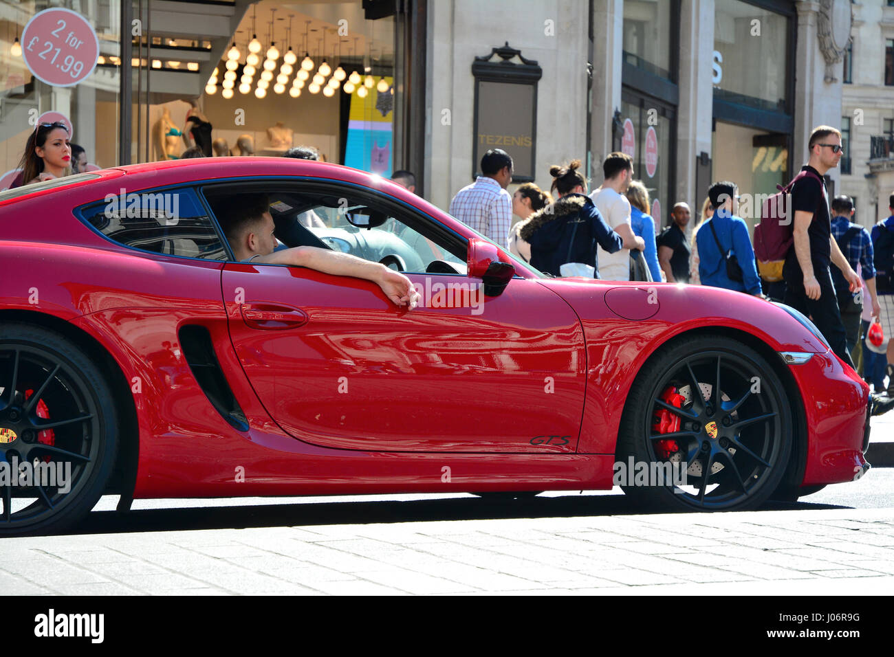 Young man cruising in his red sports car on Oxford street in London, UK ...