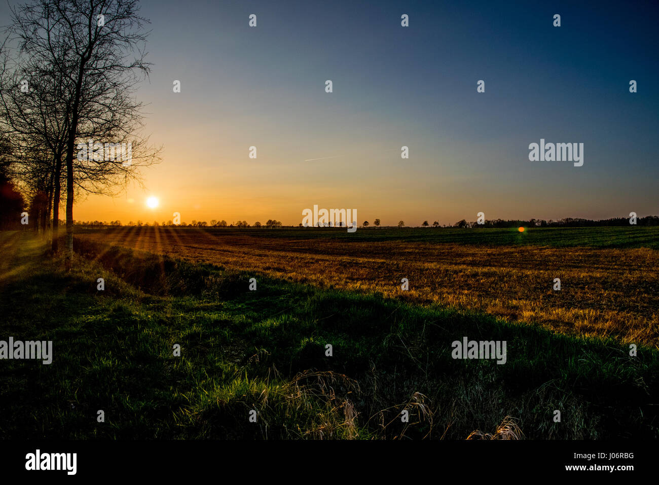 sunset view with different colors field Stock Photo - Alamy