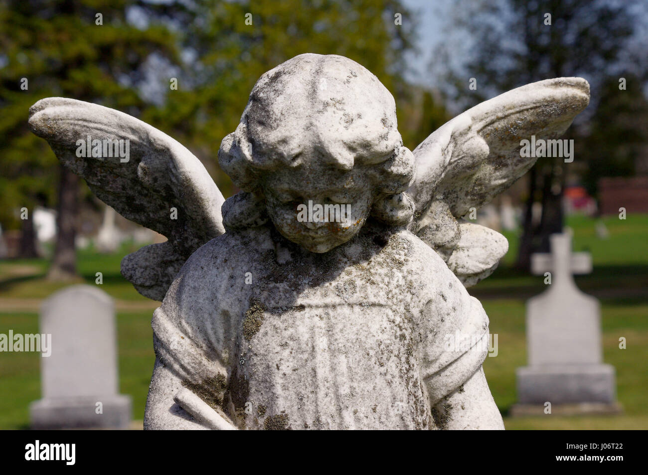 stone child angel in a children's section of a Michigan cemetery Stock ...