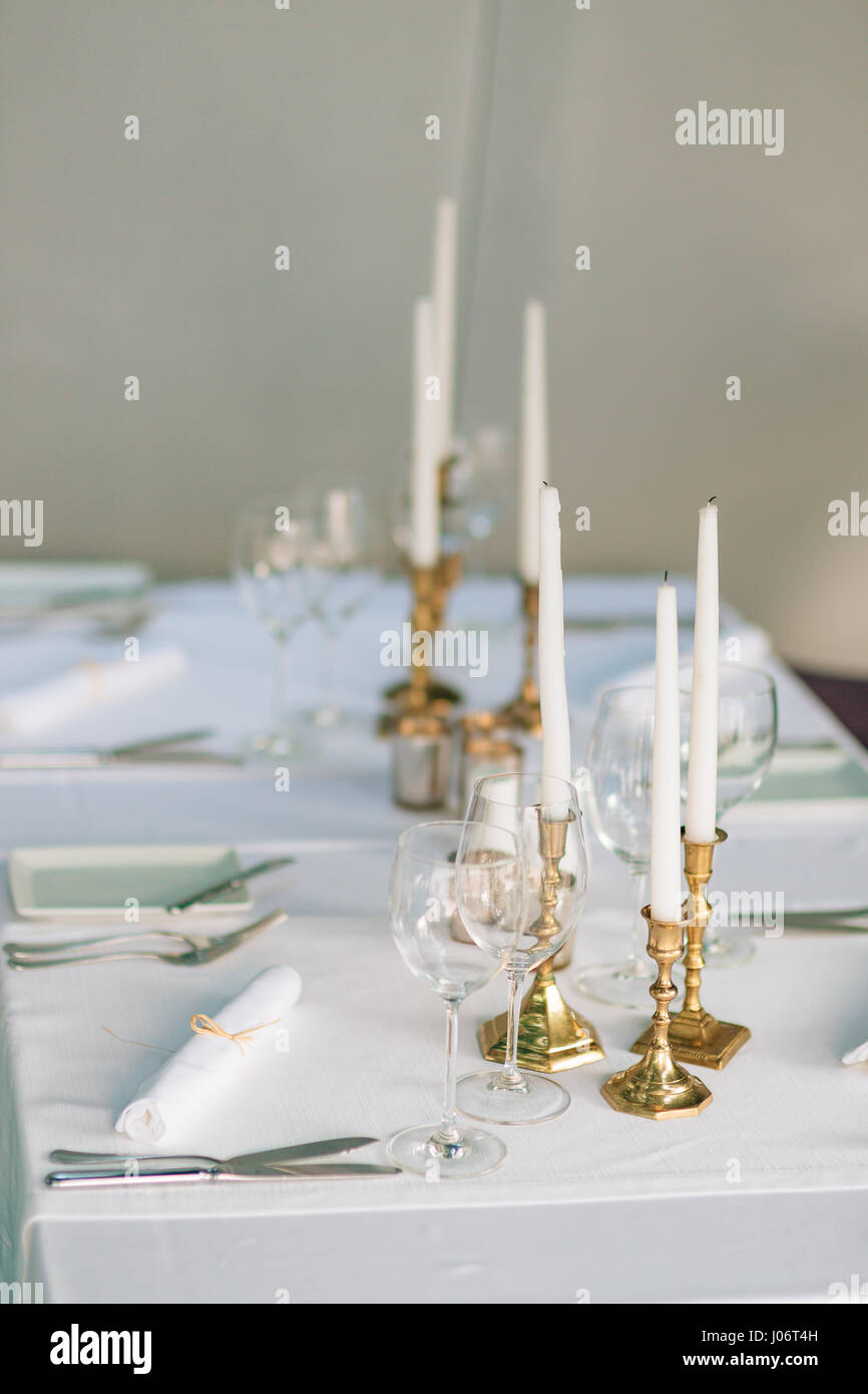 Candles on the table in the restaurant. Table setting in a cafe ...