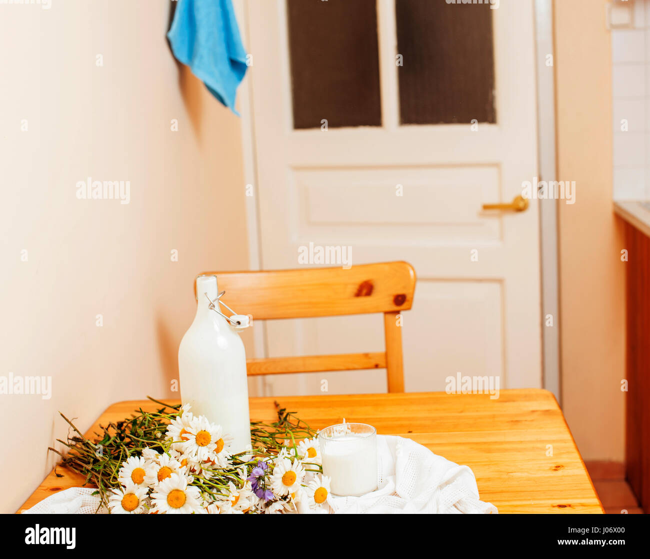 Simply stylish wooden kitchen with bottle of milk and glass on t Stock ...