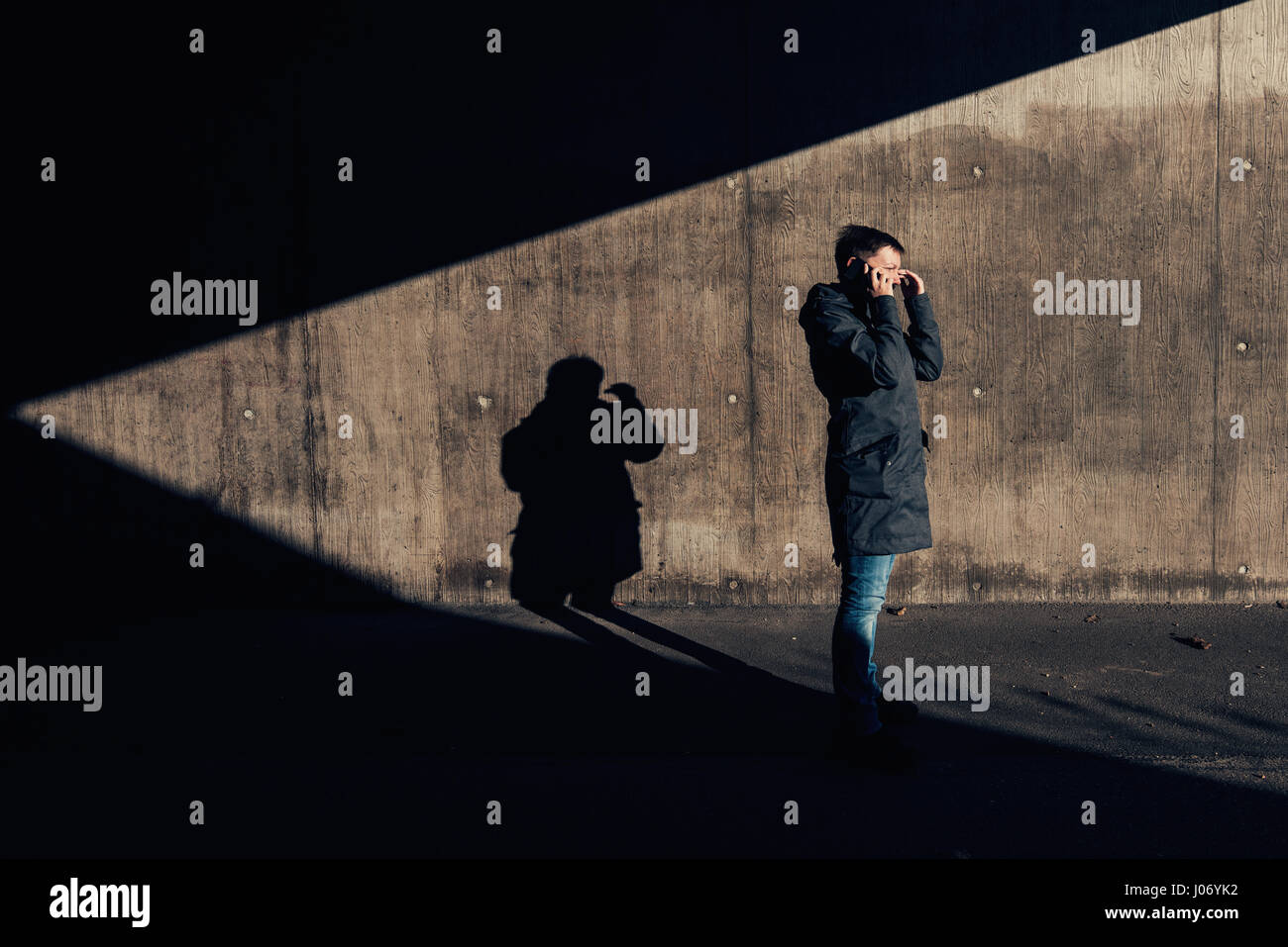Serious authentic woman with short hair talking on mobile phone on the ...
