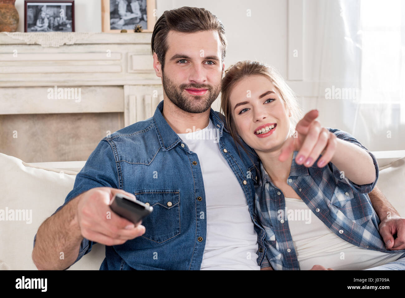 Young couple remote control sofa hi-res stock photography and images ...