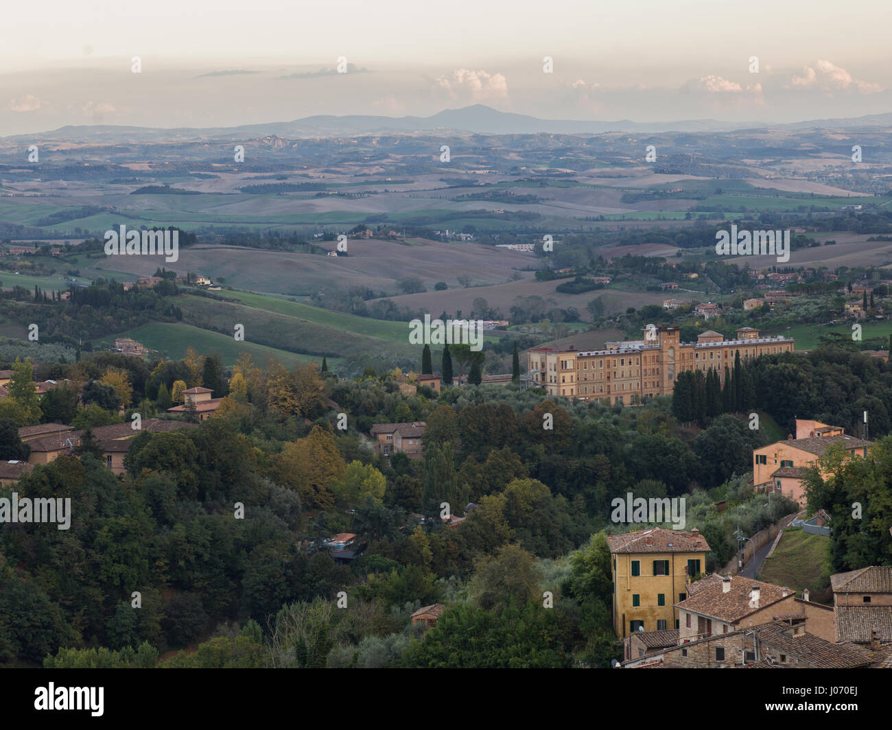 Elevated view of buildings with rural landscape in background, Siena ...