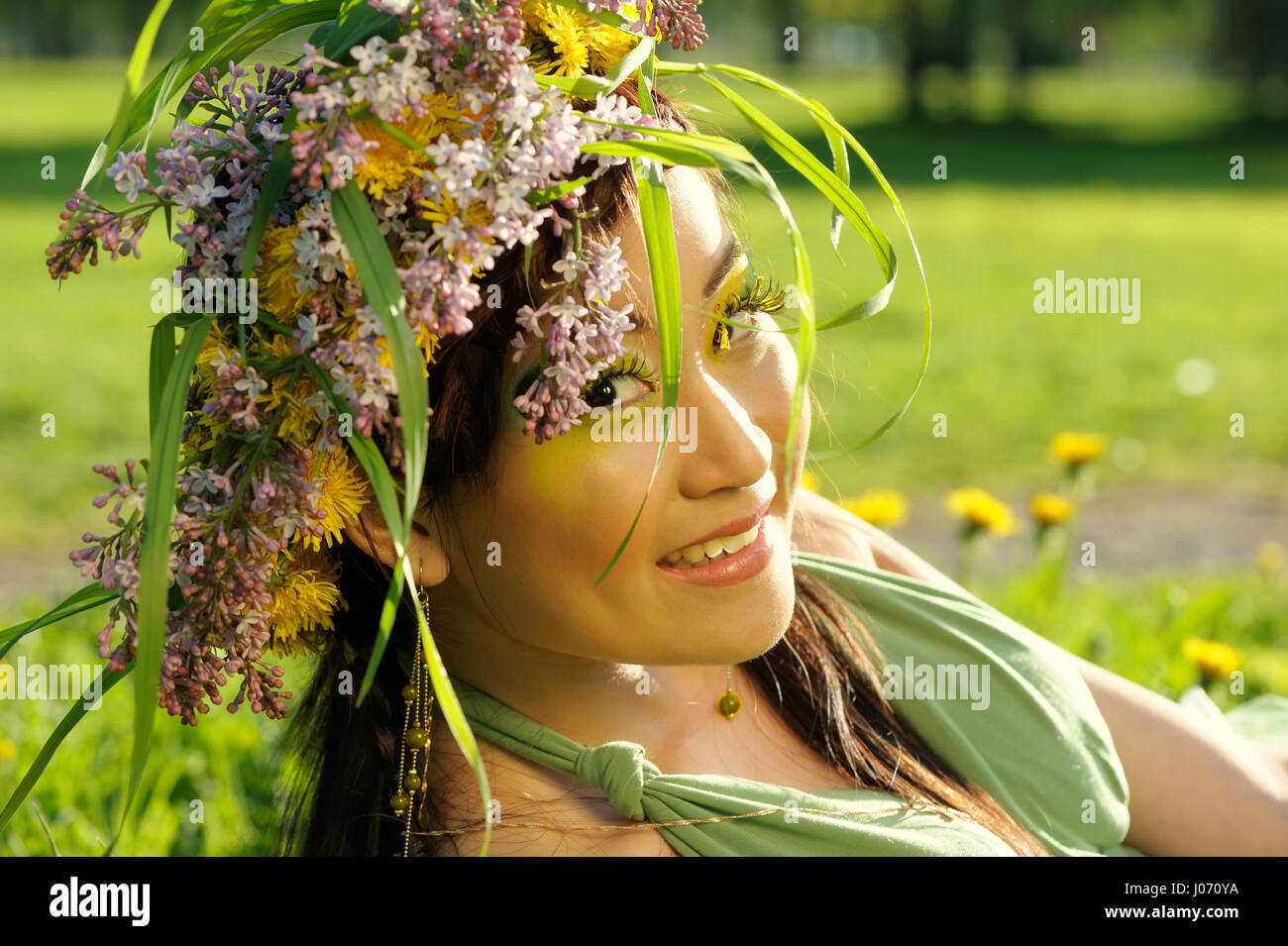 Asian woman in nature with chaplet on head Stock Photo - Alamy