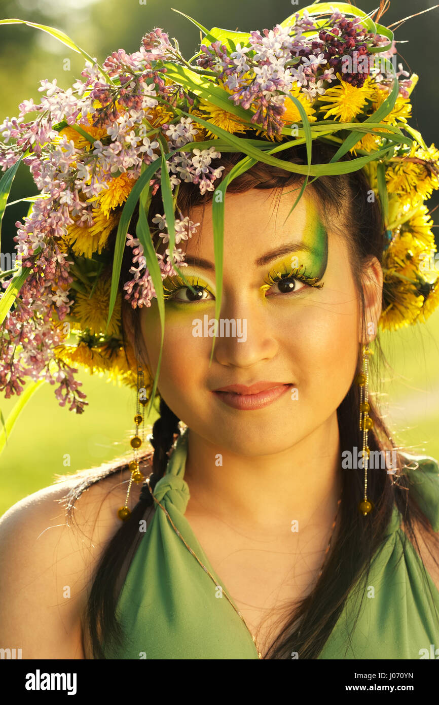 Asian woman in nature with chaplet on head Stock Photo - Alamy