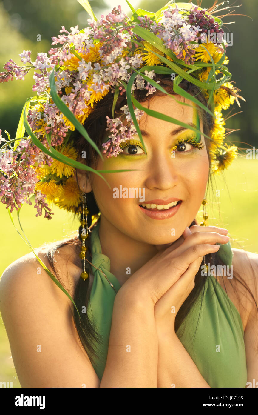 Asian woman in nature with chaplet on head Stock Photo - Alamy