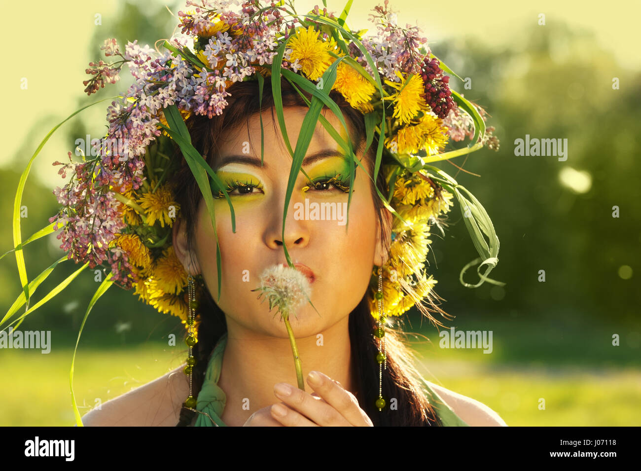 Asian woman in nature with chaplet on head Stock Photo - Alamy