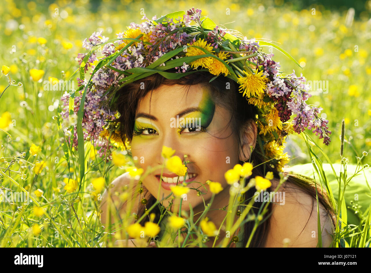 Asian woman in nature with chaplet on head Stock Photo - Alamy