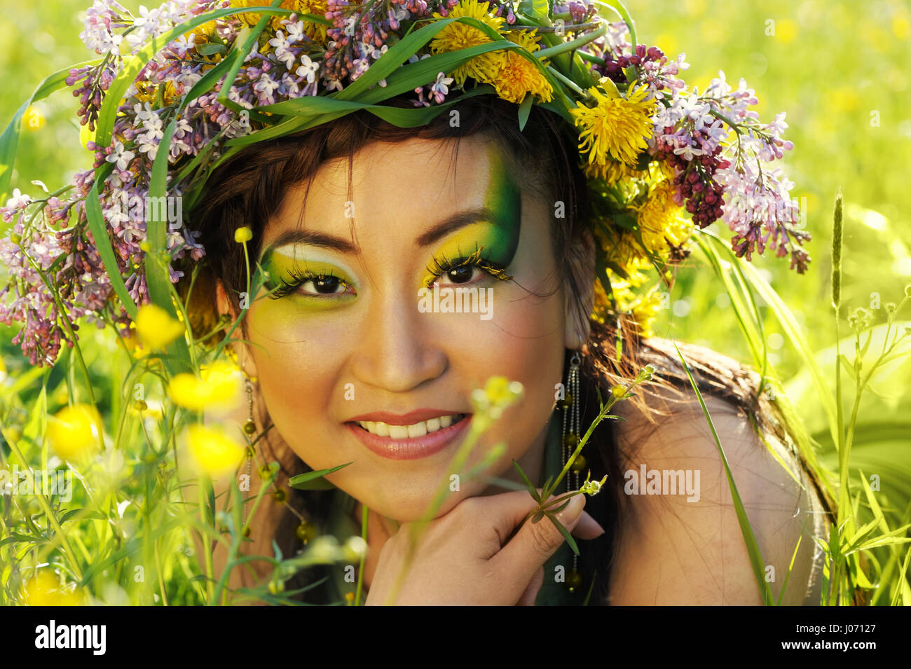 Asian woman in nature with chaplet on head Stock Photo - Alamy