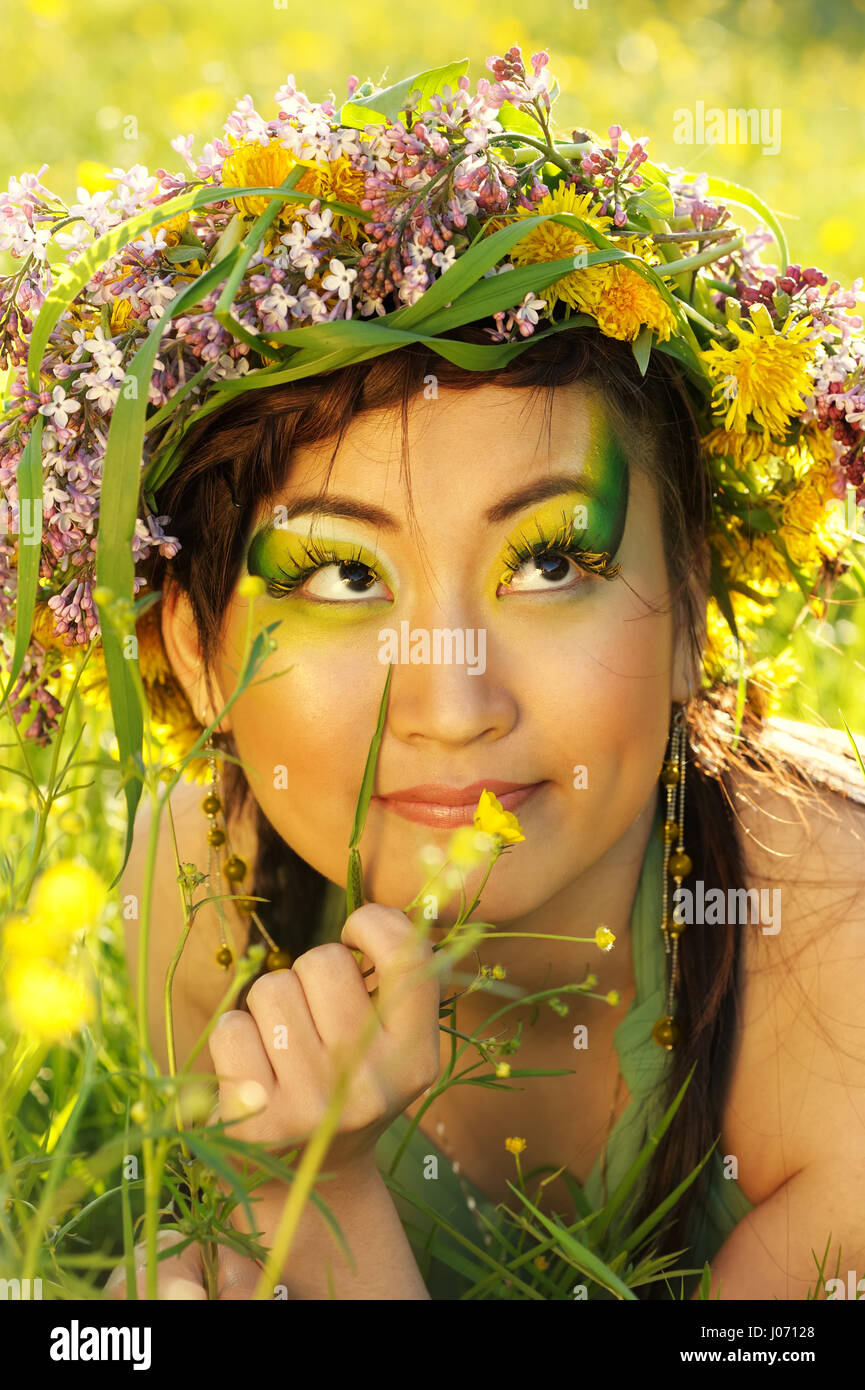 Asian woman in nature with chaplet on head Stock Photo - Alamy