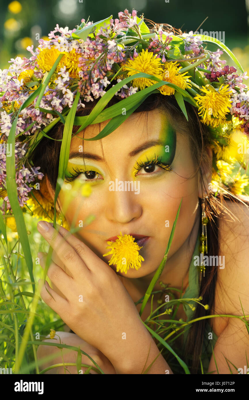 Asian woman in nature with chaplet on head Stock Photo - Alamy