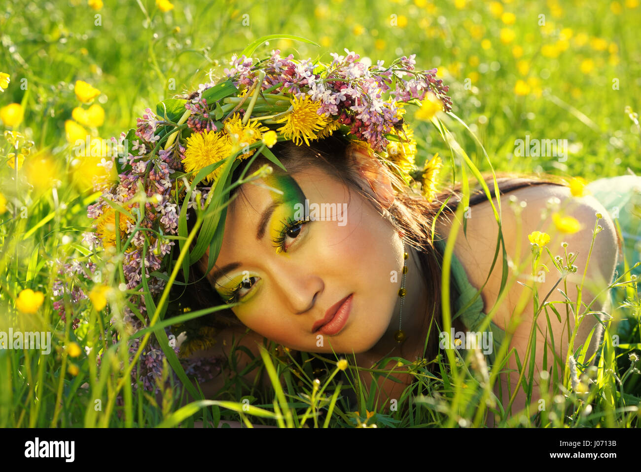 Asian woman in nature with chaplet on head Stock Photo - Alamy