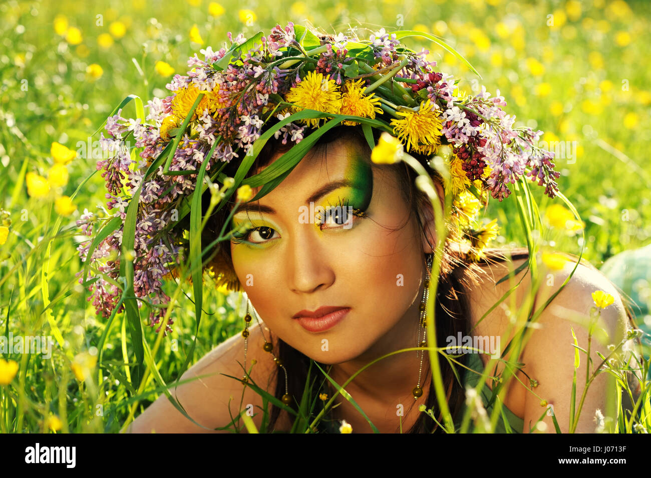 Asian woman in nature with chaplet on head Stock Photo - Alamy