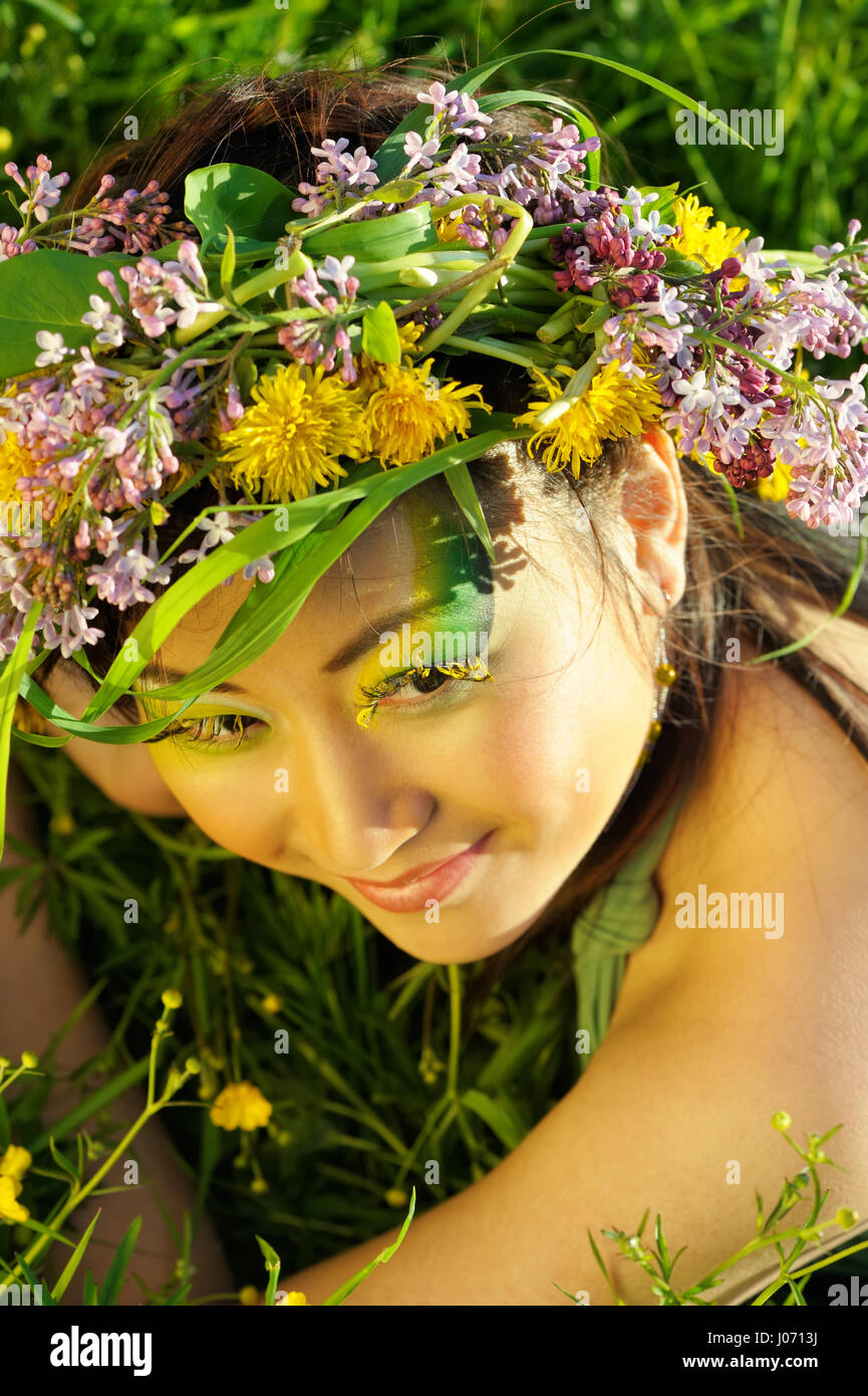 Asian woman in nature with chaplet on head Stock Photo - Alamy