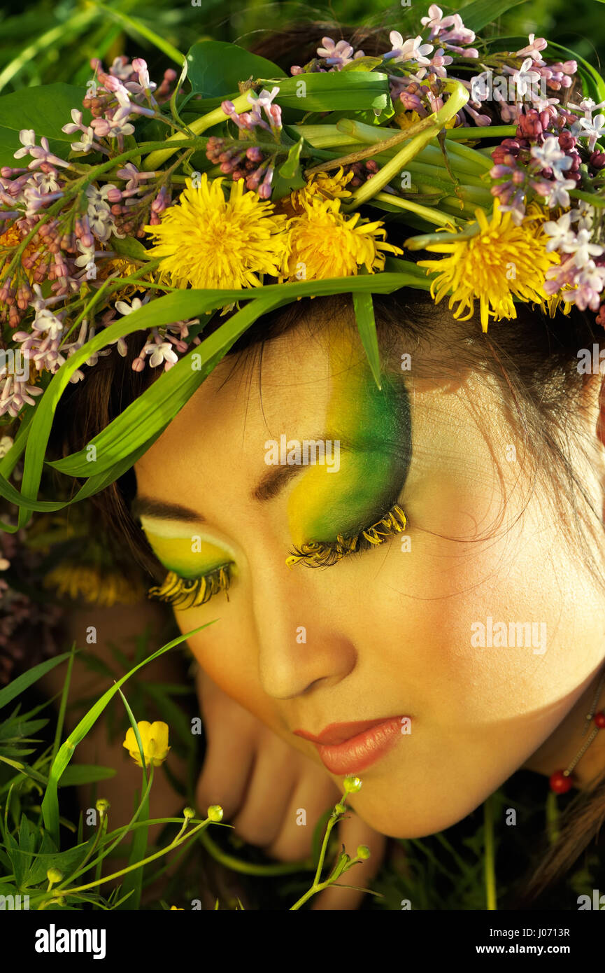 Asian woman in nature with chaplet on head Stock Photo - Alamy