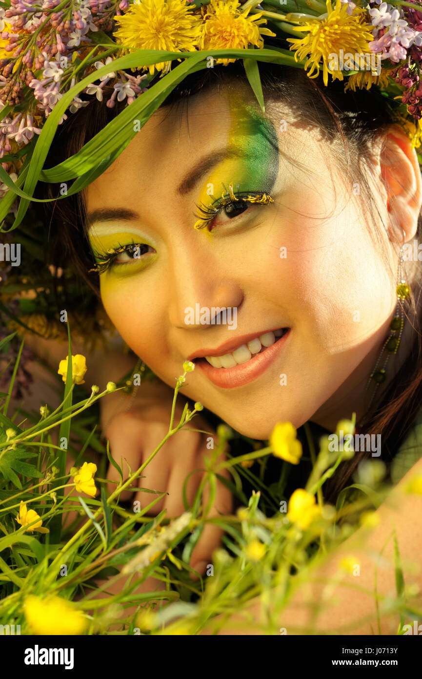 Asian woman in nature with chaplet on head Stock Photo - Alamy