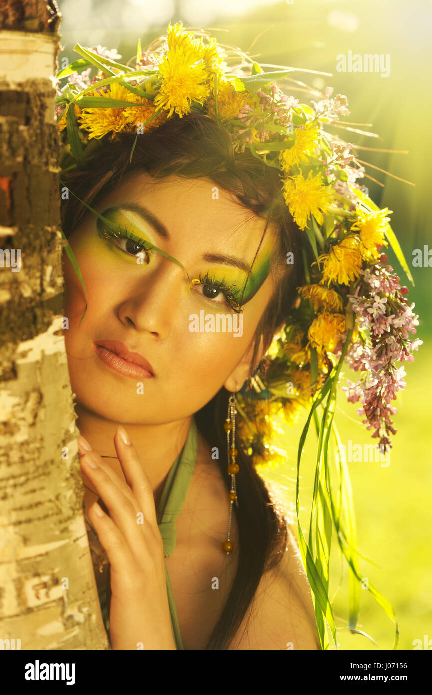 Asian woman in nature with chaplet on head Stock Photo - Alamy