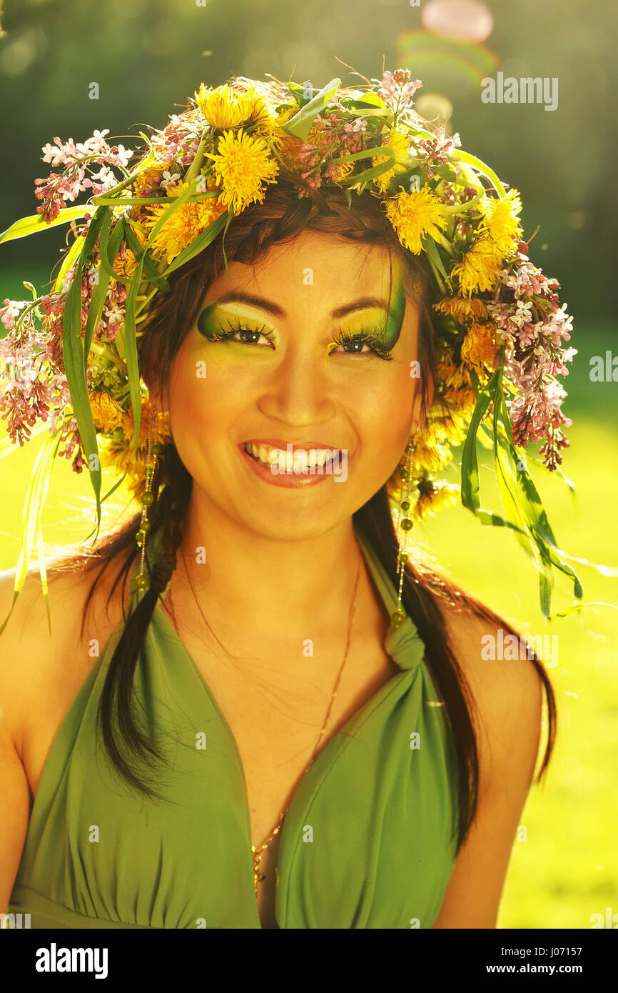 Asian woman in nature with chaplet on head Stock Photo - Alamy