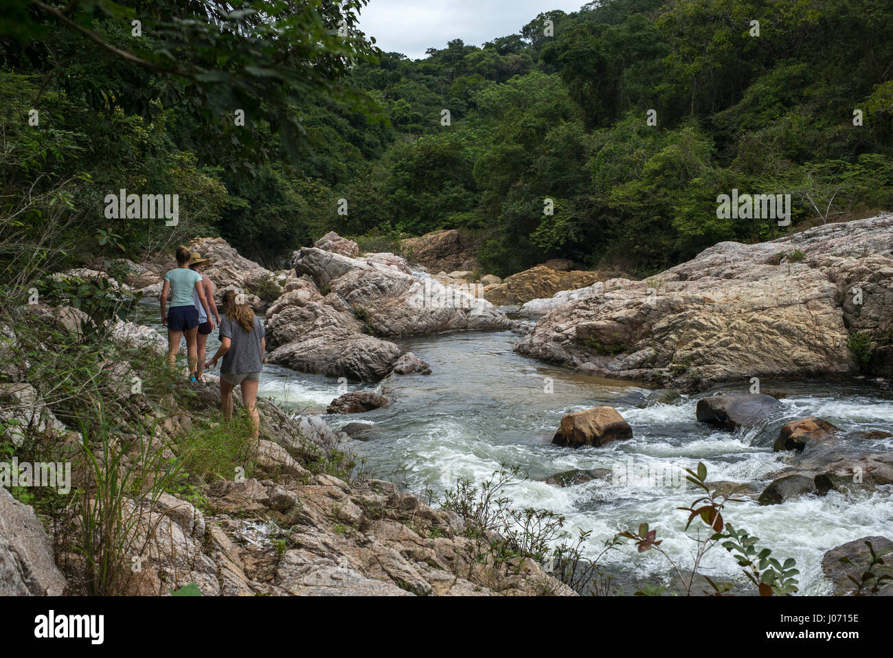 Tourists walking along river in forest, Yelapa, Jalisco, Mexico Stock ...