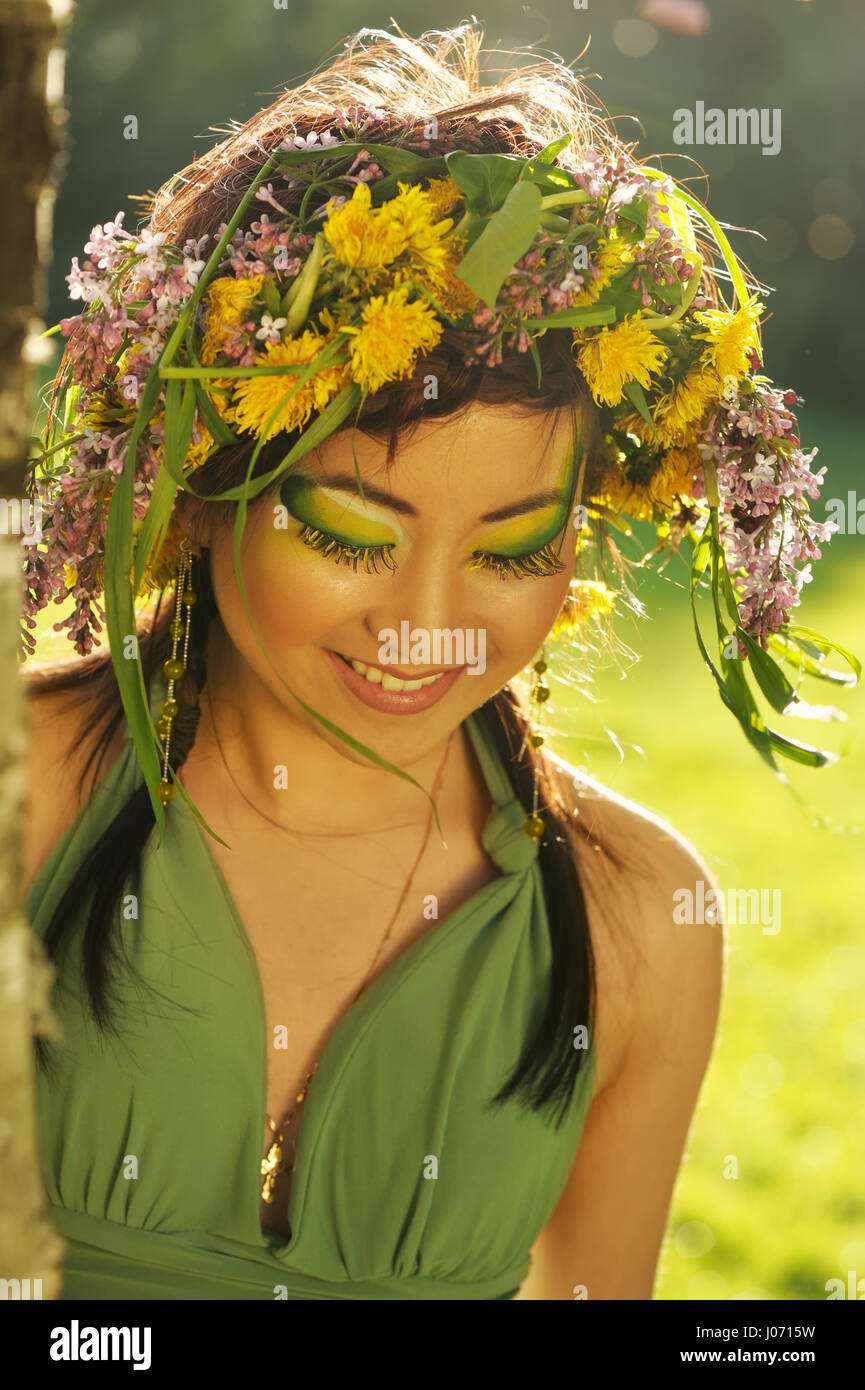 Asian woman in nature with chaplet on head Stock Photo - Alamy