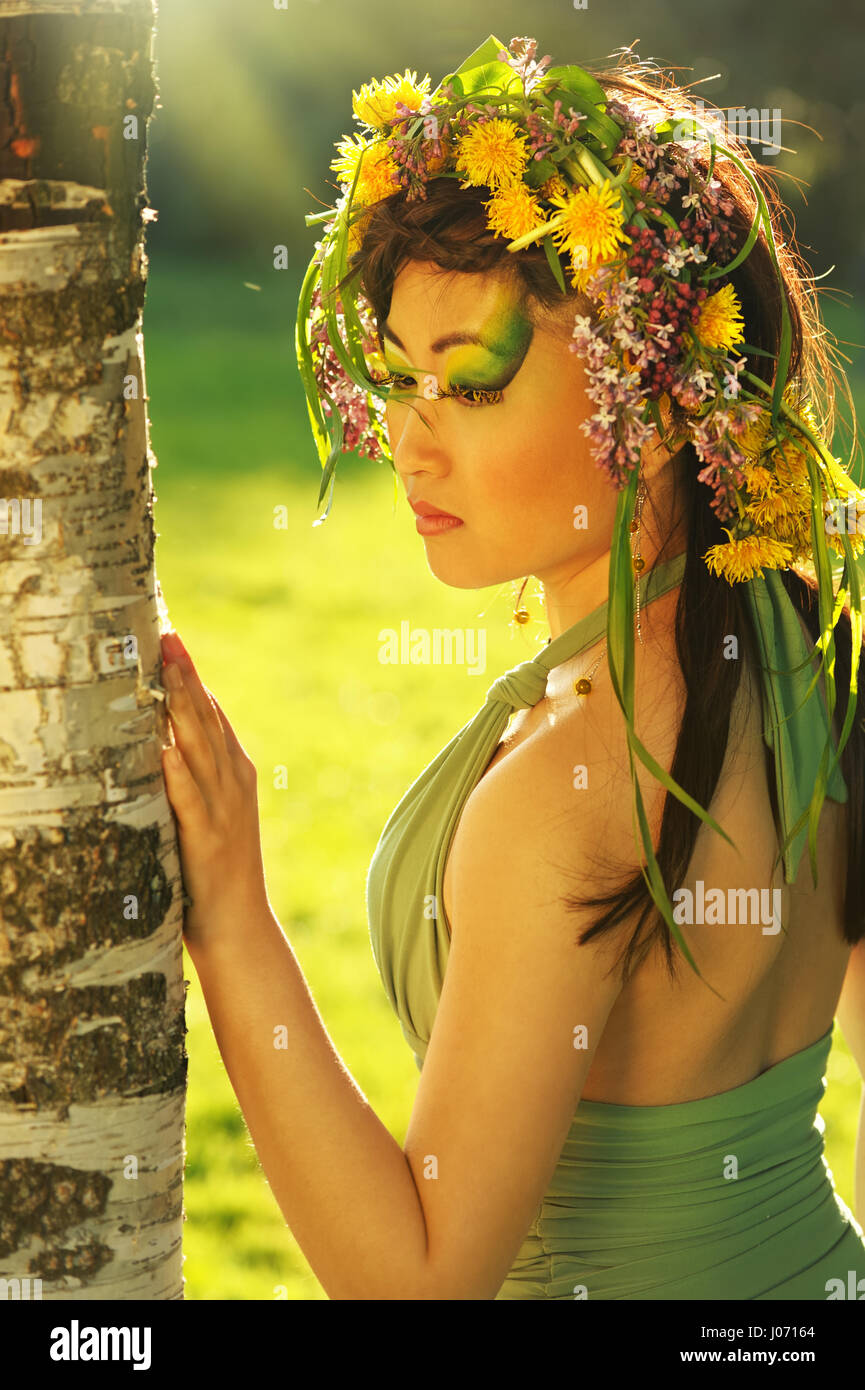 Asian woman in nature with chaplet on head Stock Photo - Alamy