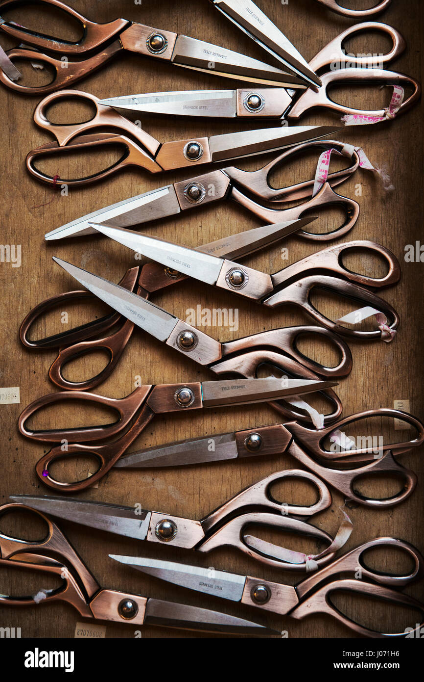 A row of used and worn scissors on a tabletop Stock Photo - Alamy