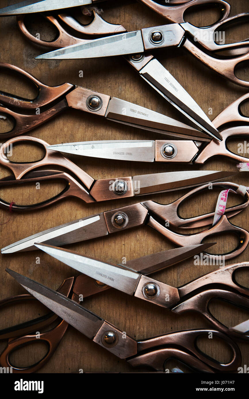 A row of used and worn scissors on a tabletop Stock Photo - Alamy