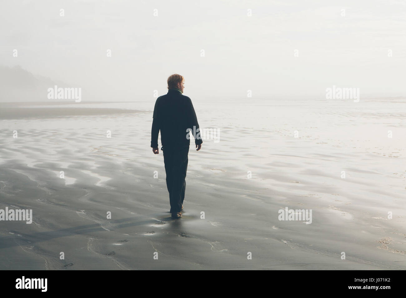 Middle aged man walking on a beach at Seabrook, Washington, USA Stock ...