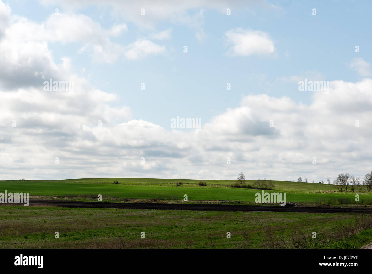 countryside fields in early spring with clouds and farmland Stock Photo ...