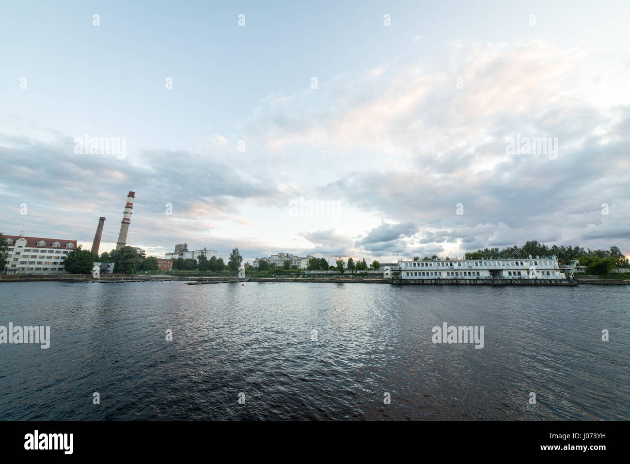Beautiful summer sunset in the sea port with blue sky, red and orange ...