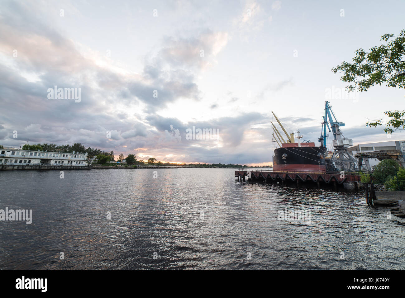 Beautiful summer sunset in the sea port with blue sky, red and orange ...
