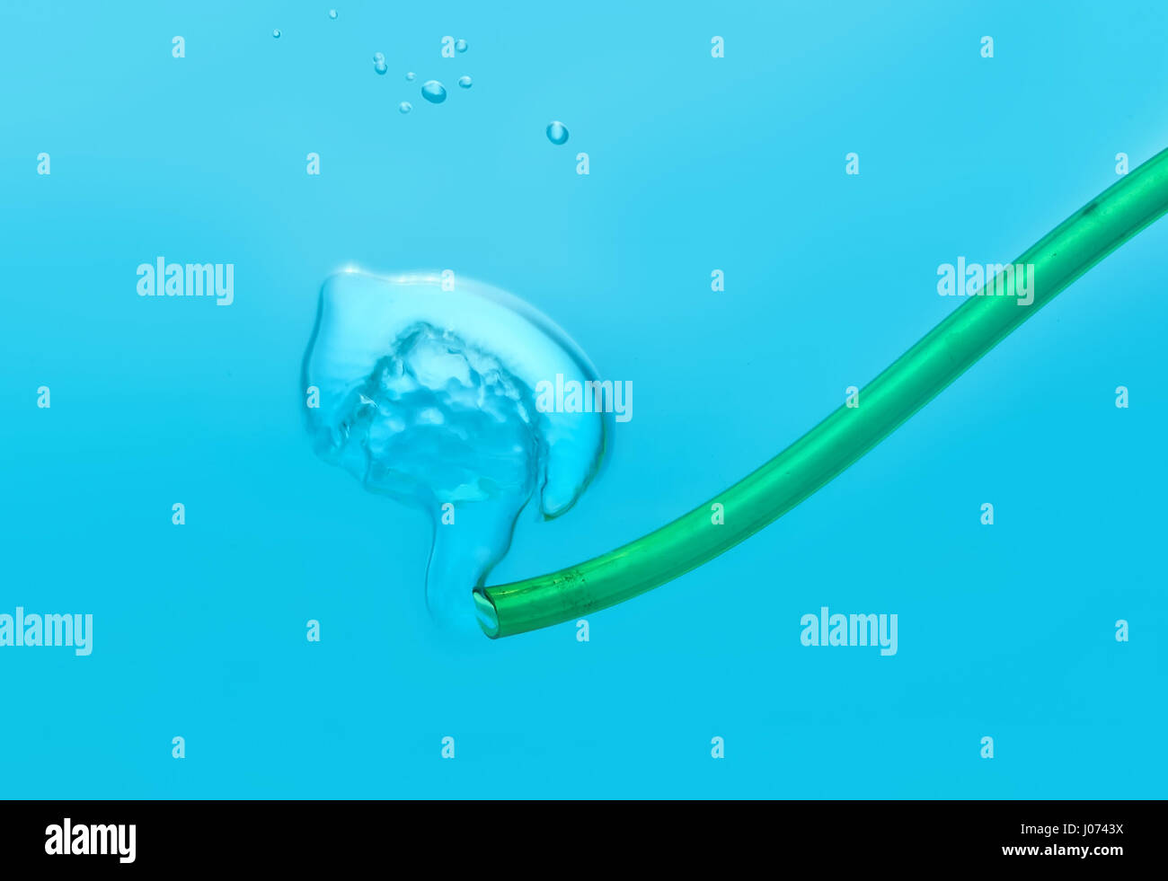 Bubbles from tube in water Stock Photo - Alamy