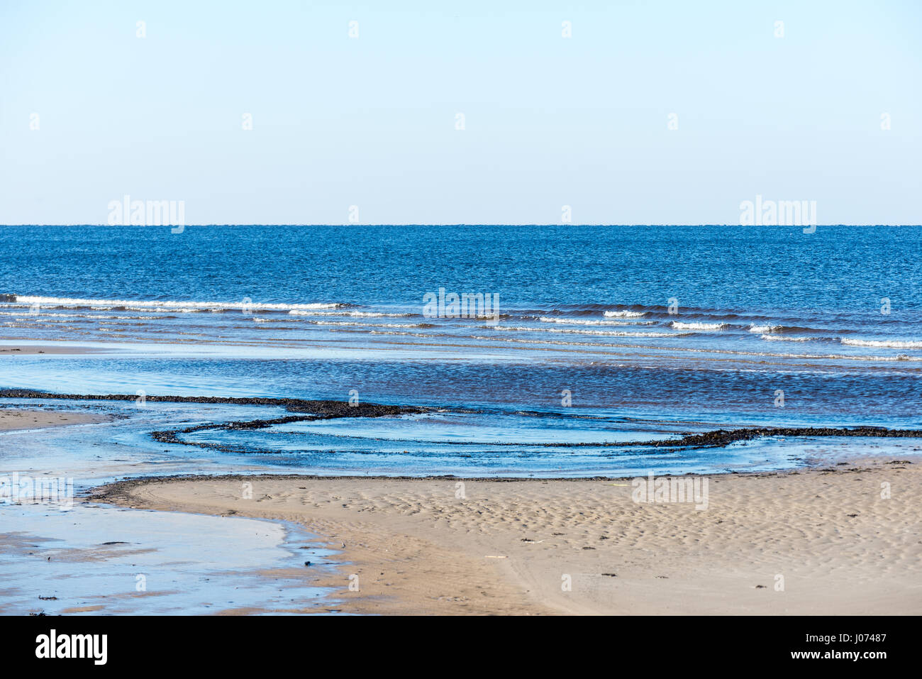 icy sea beach with first ice pieces in baltic sea. latvia Stock Photo ...