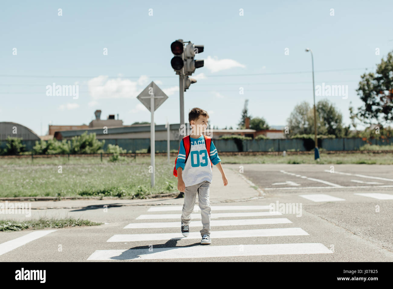 Schoolboy crossing a road on his morning way to school Stock Photo - Alamy