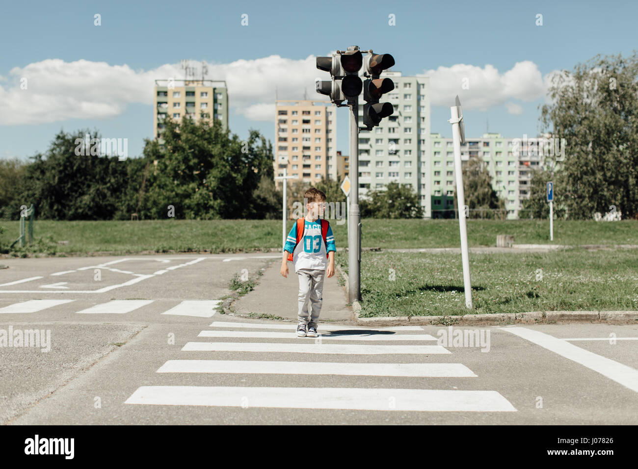 Schoolboy crossing a road on his morning way to school Stock Photo - Alamy