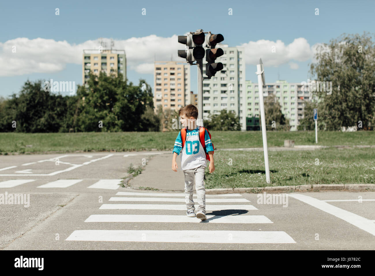 Schoolboy crossing a road on his morning way to school Stock Photo - Alamy
