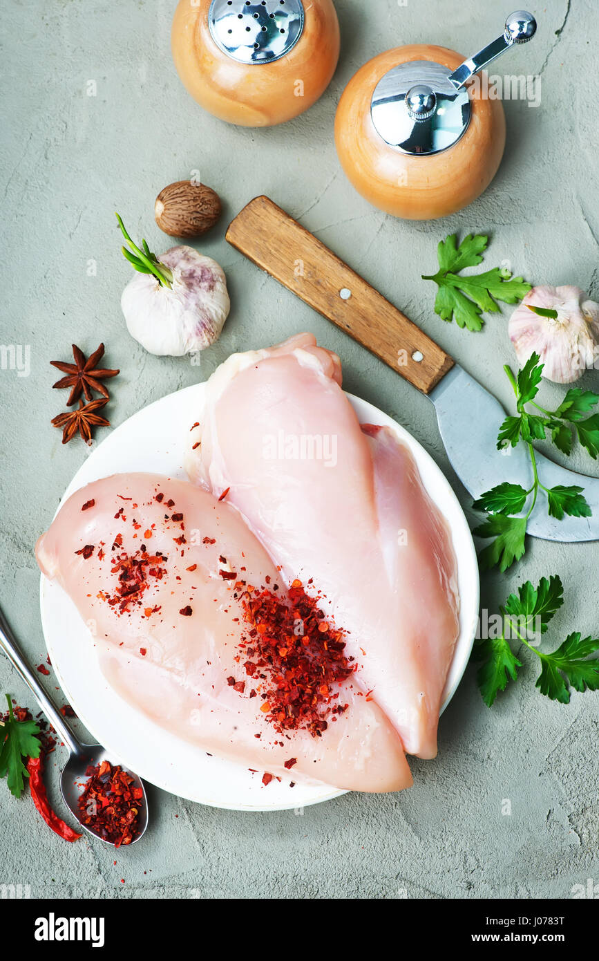 raw chicken fillet with spice on the board Stock Photo - Alamy