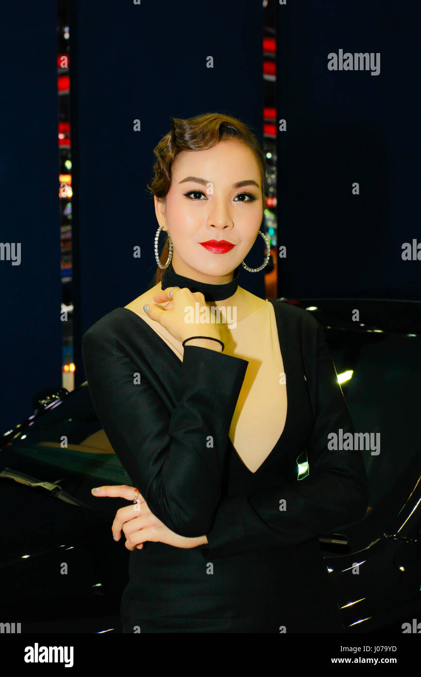 BANGKOK, THAILAND - APRIL 09, 2017: Unidentified female presenter pose ...